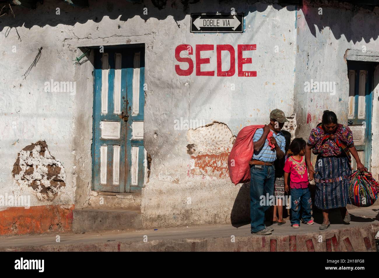 A family on a street corner in the colonial town of Momostenango ...