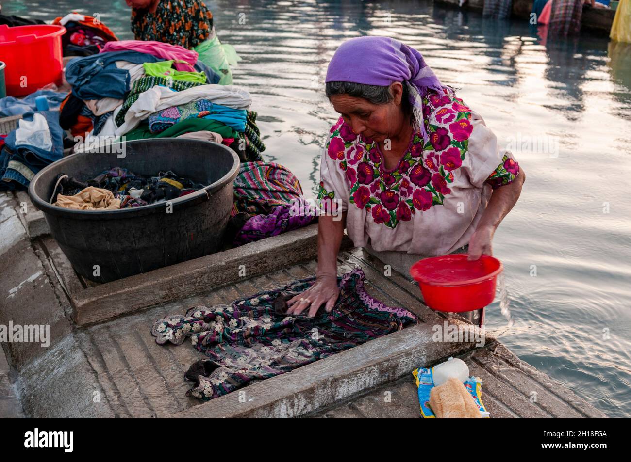 A woman washing clothes at a public laundry. Totonicapan, Guatemala ...