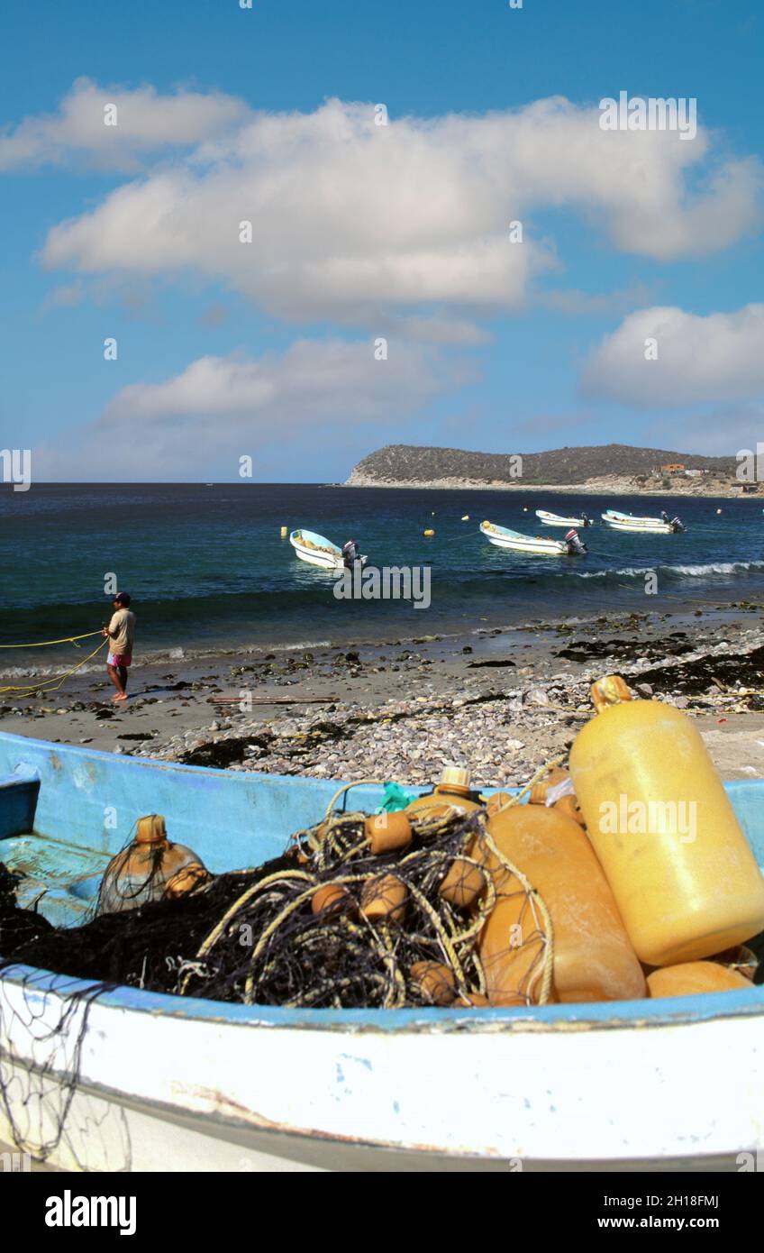 Fishing nets in boat on beach, net fisherman and boats anchored in bay ...