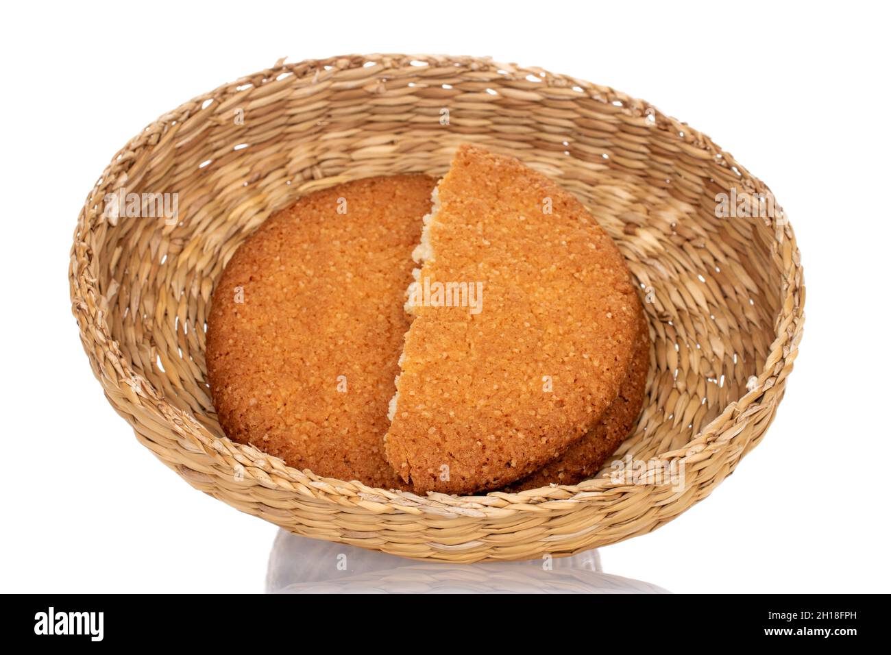 One whole and one half freshly baked round American pastry in a straw ...