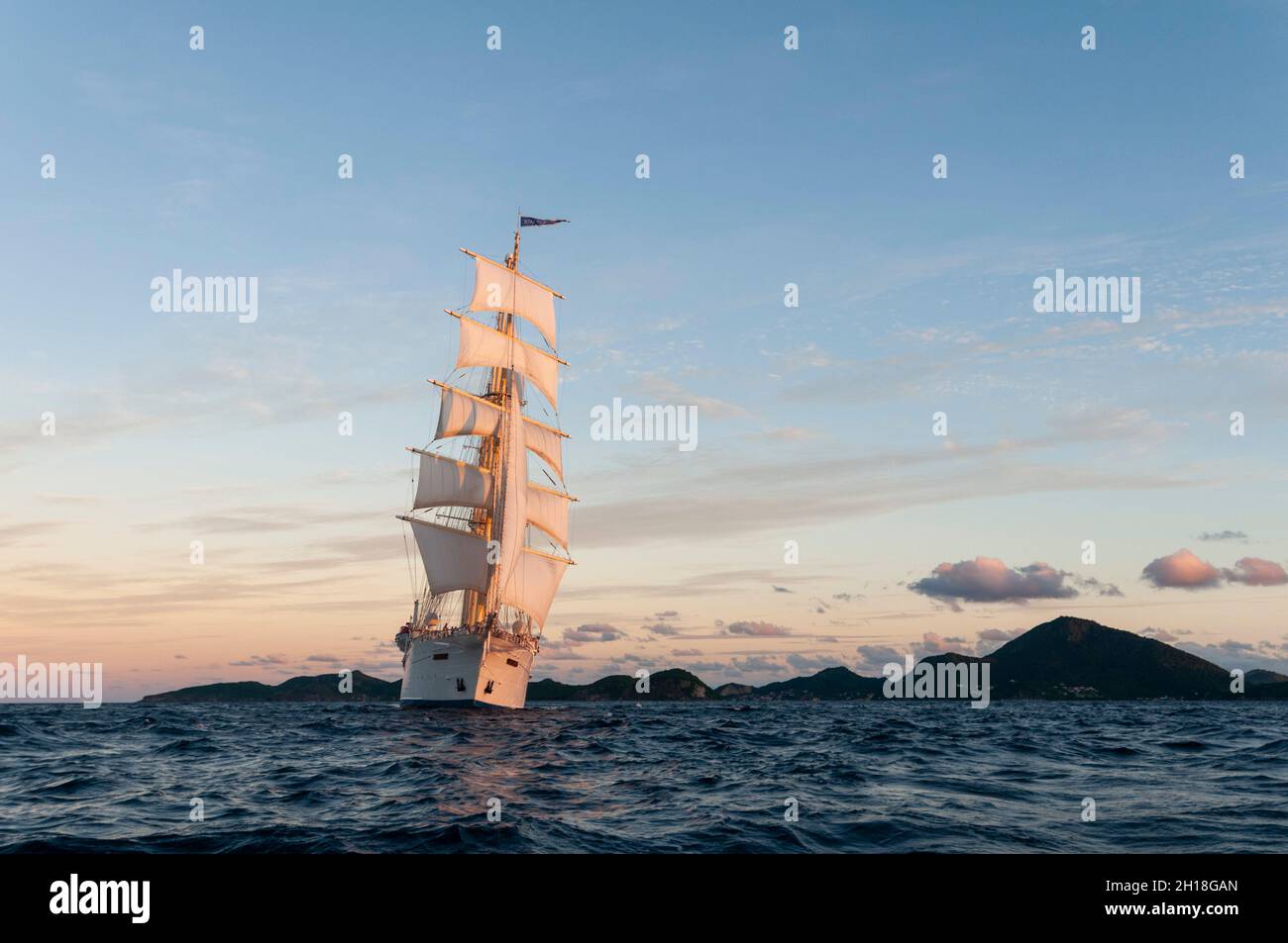 Morning light illuminates a Star Clipper barquentine tall ship sailing ...