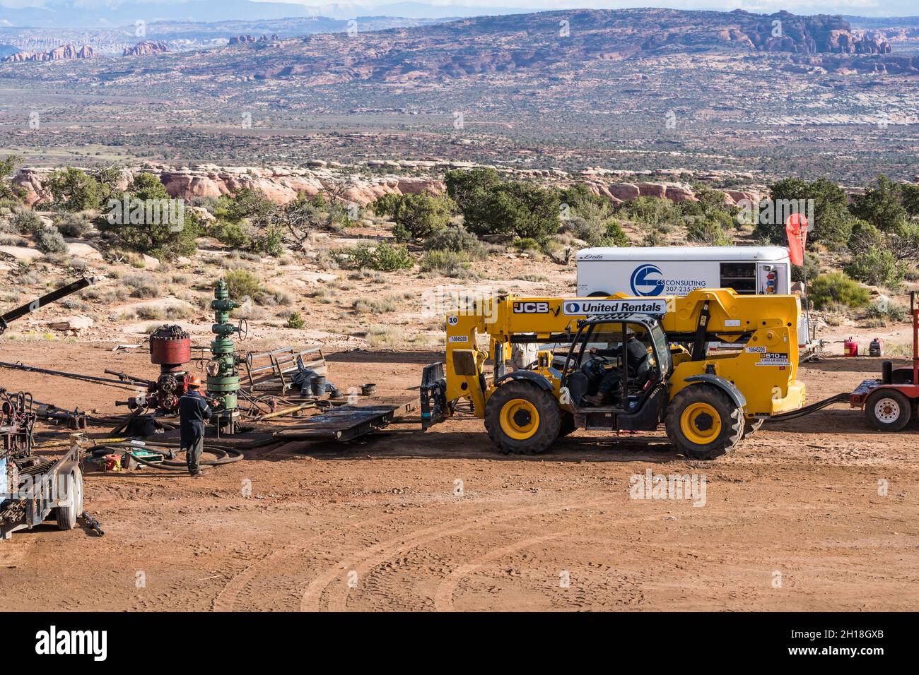 The well service crew picks up the rear load beam for a workover rig ...