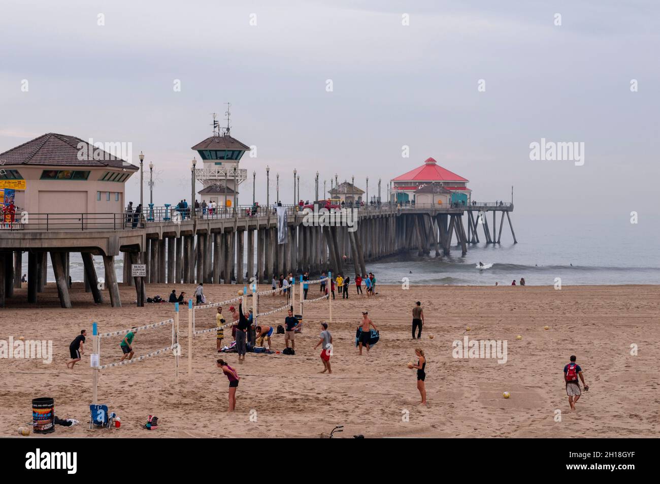 People play beach volleyball at Huntington Beach pier. Huntington Beach ...