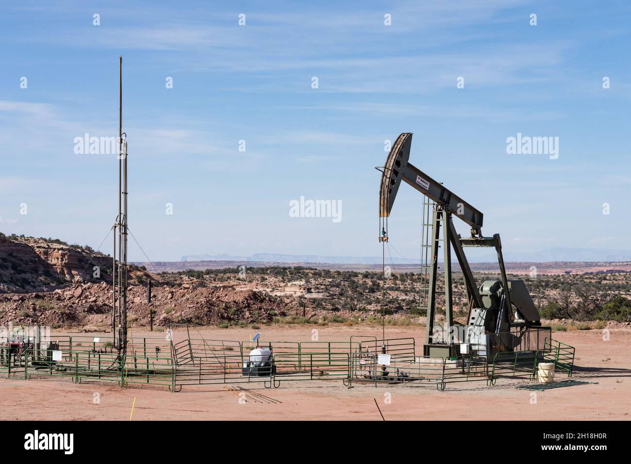 A conventional horsehead oil well pump jack and a hydraulic pumping ...