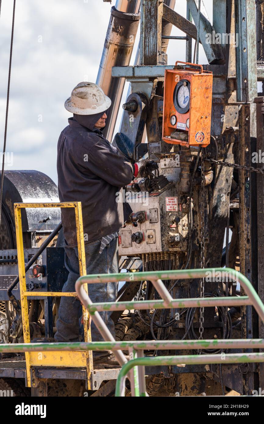 The operator on a well service workover rig running the controls on the ...