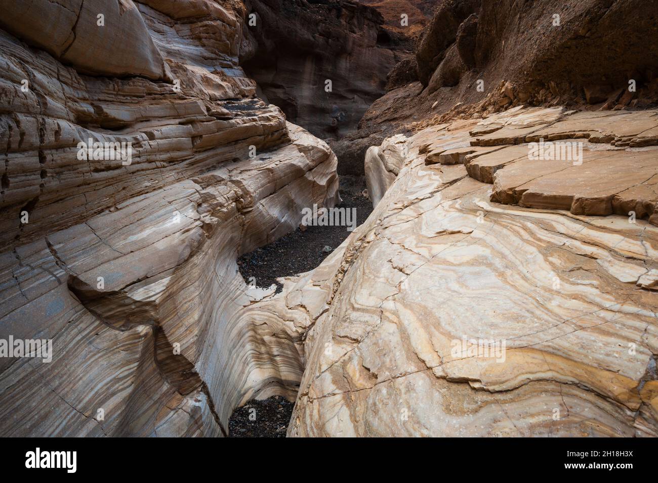 An asphalt trail leads through the smooth white polished marble walls ...