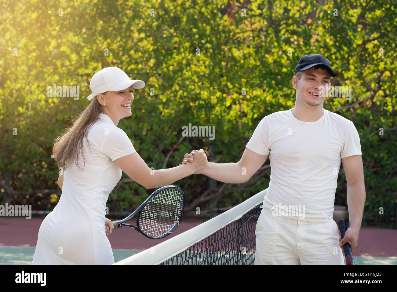 Handshake After A Tennis Match Played A White Young Man And A Woman