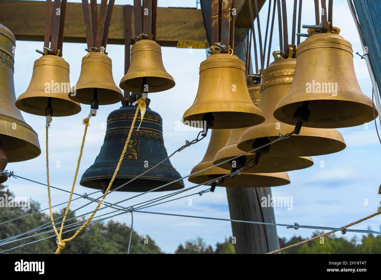 Church bells hanging in a wooden bell tower. church bellson a wooden ...