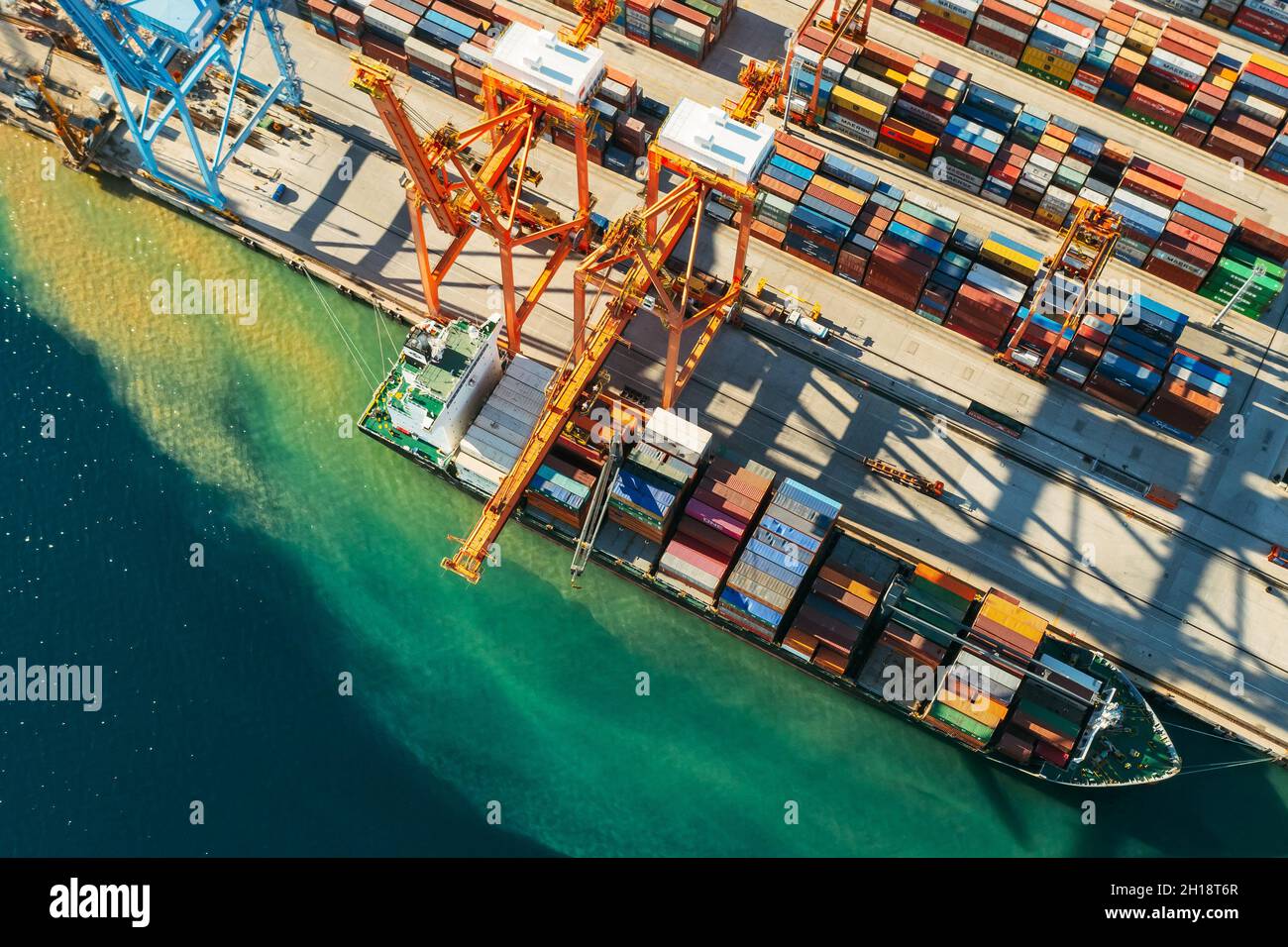 Aerial view of containers loading and unloading to the ship in the sea ...