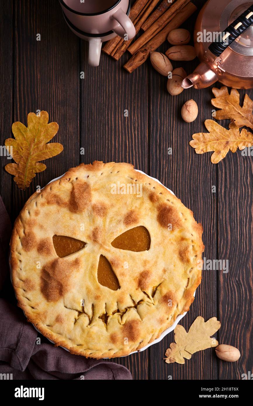 Halloween food. Homemade pumpkin pie or tart with a scary face for ...