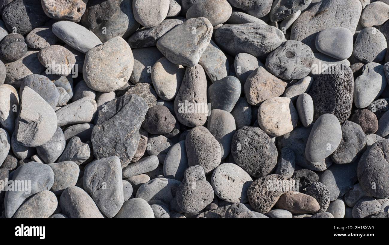 Grey smooth pebble beach background with copy space, conceptual texture ...