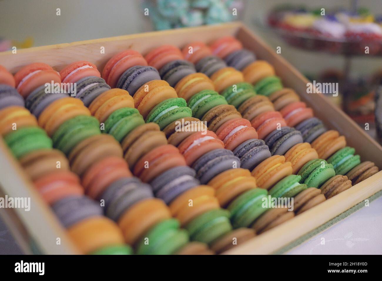 Large wooden display of colorful macarons or French macaroon, a sweet ...