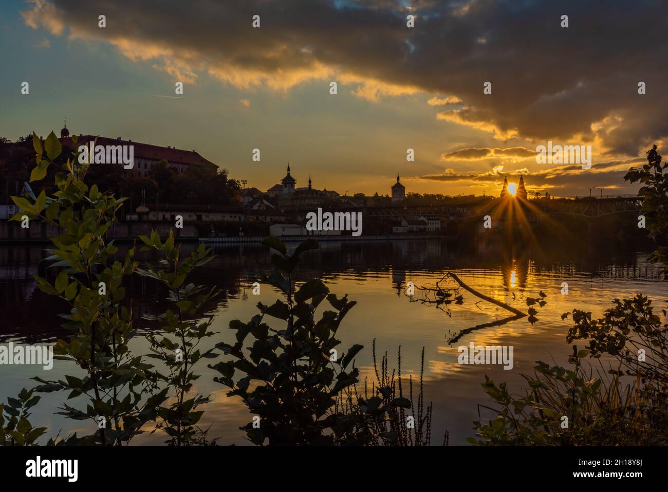 Orange sunset in Roudnice nad Labem town with old church and towers ...