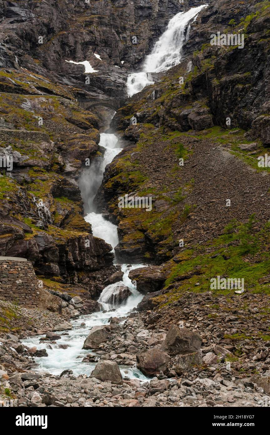 Stigfossen waterfall surges past rock outcroppings near Trollstigen ...