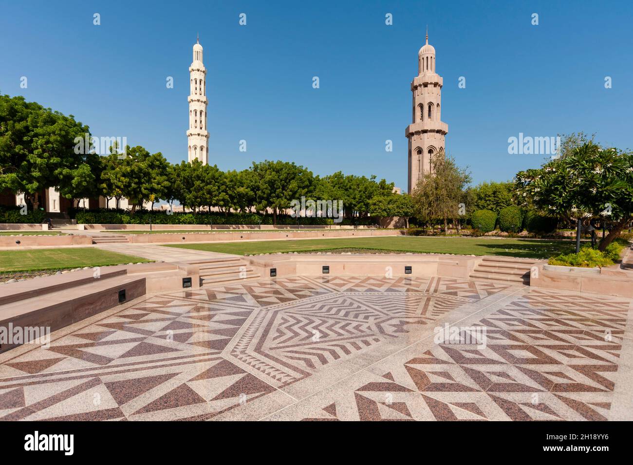 A courtyard, gardens, and minarets at Sultan Qaboos Grand Mosque, in ...