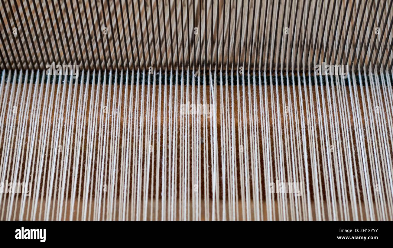 Abstract shot of a vintage handloom weaving machine, with focus on the ...