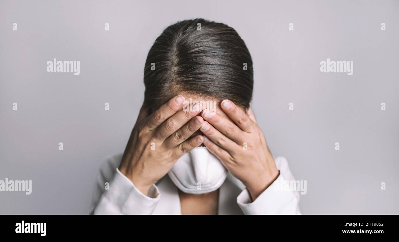 COVID-19 Stress business woman crying covering face mask with hands ...