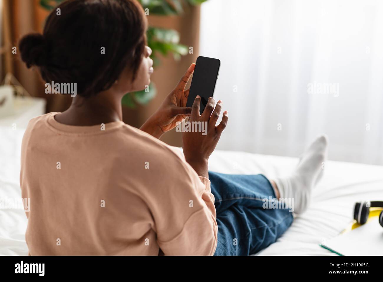 Back-View Of Black Lady Using Phone With Blank Screen Indoor Stock ...