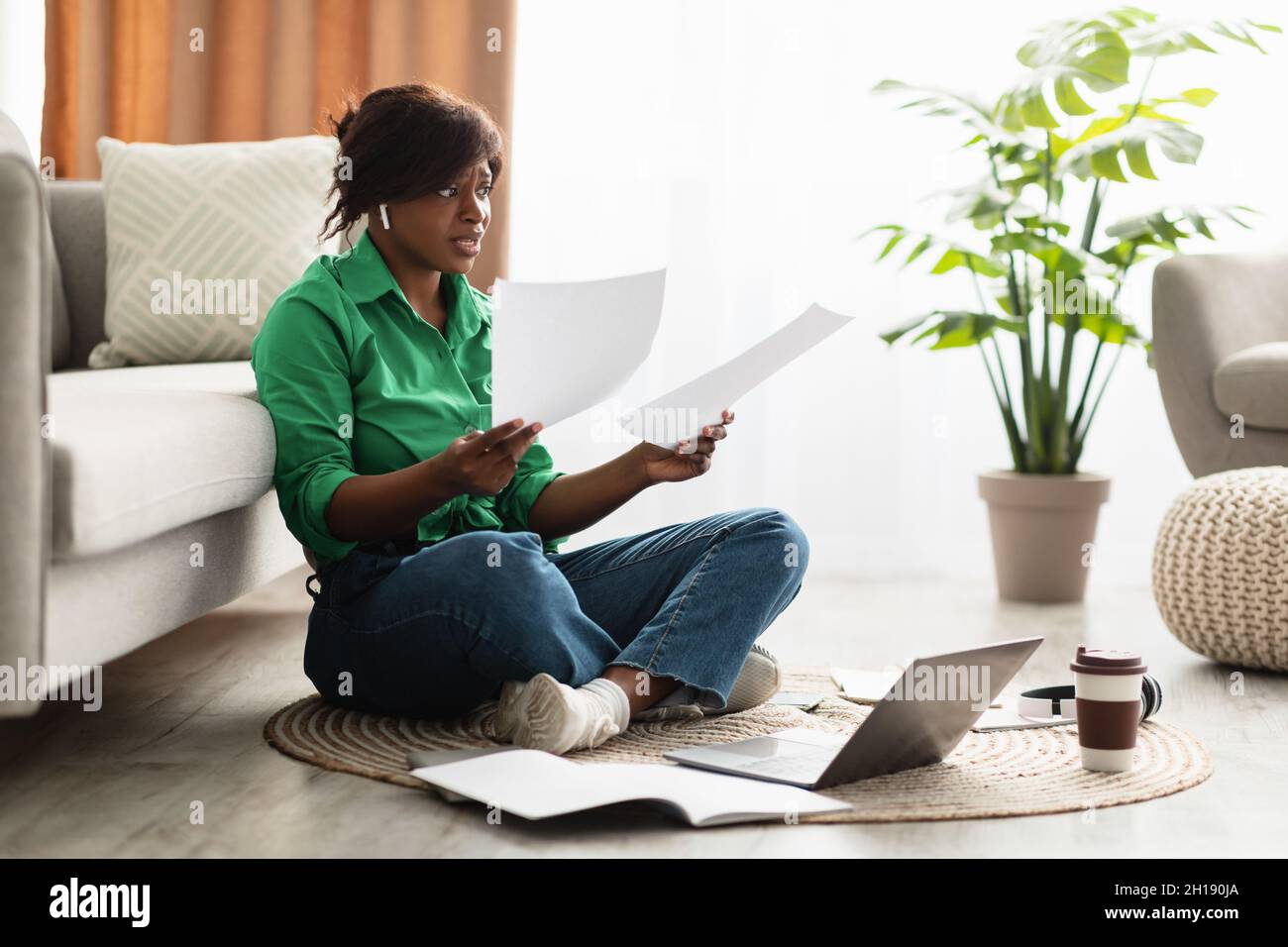 Unhappy African Woman Reading Negative Letters Sitting At Laptop Indoor ...