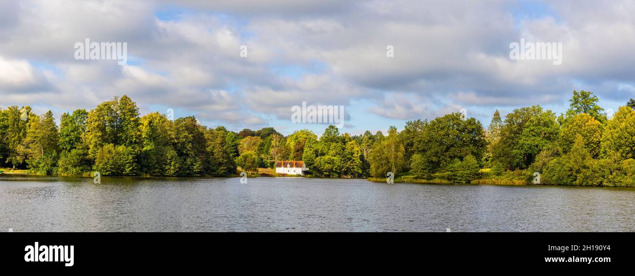View across Virginia Water lake towards a modern boathouse by the site ...