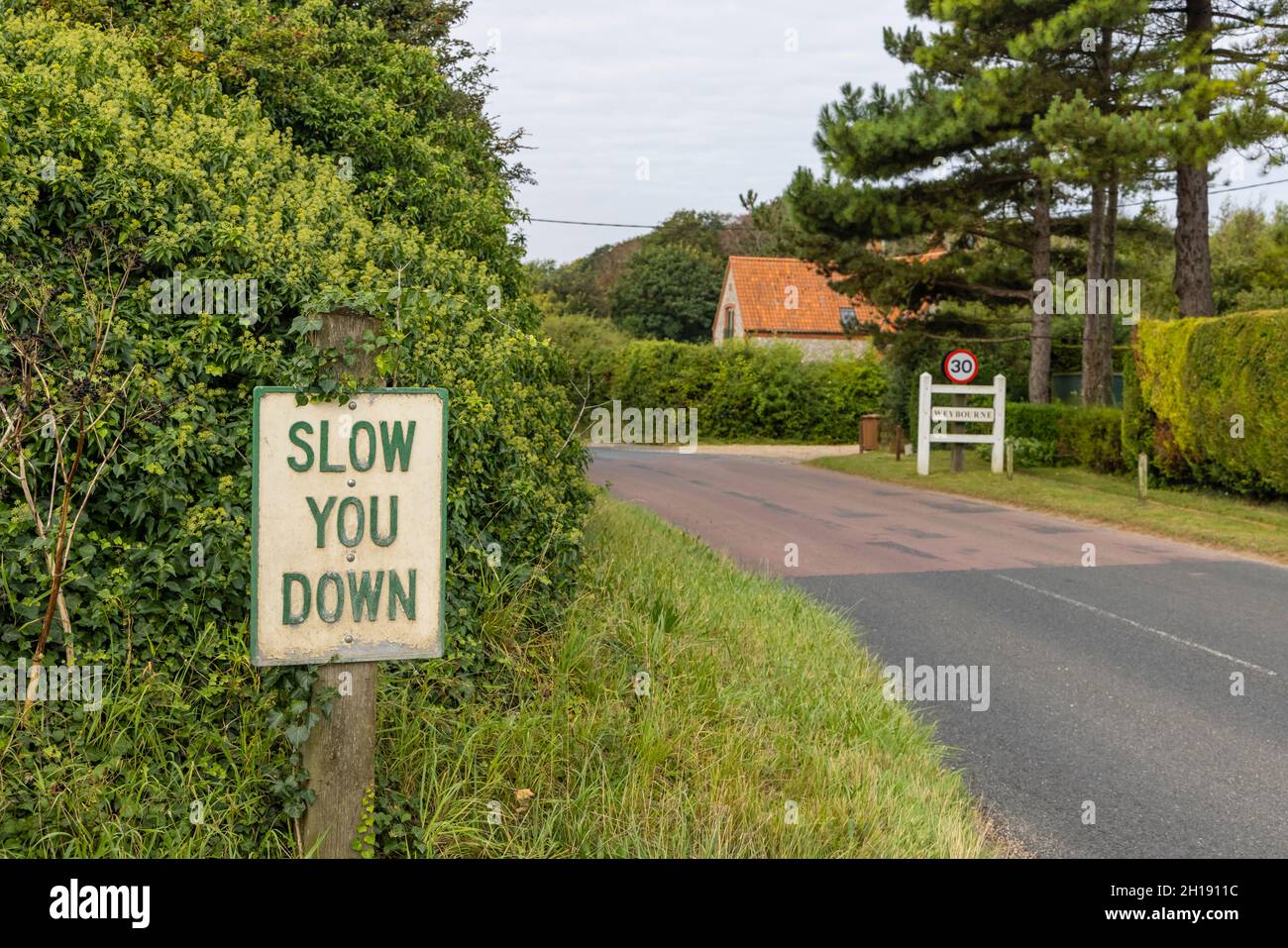Roadside road speed sign 'Slow you down' approaching Weybourne on the ...