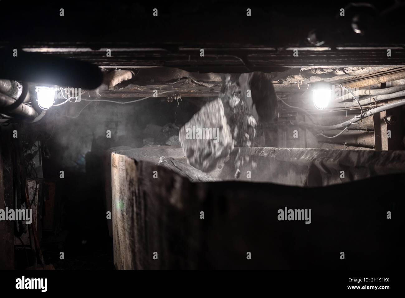 Loading a mine car with ore and stones. The ore falls into the minecart ...