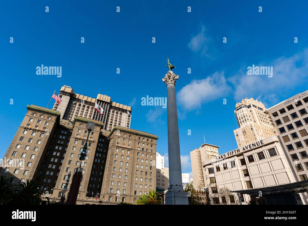 Low angle view of a statue atop a pillar and buildings around Union ...