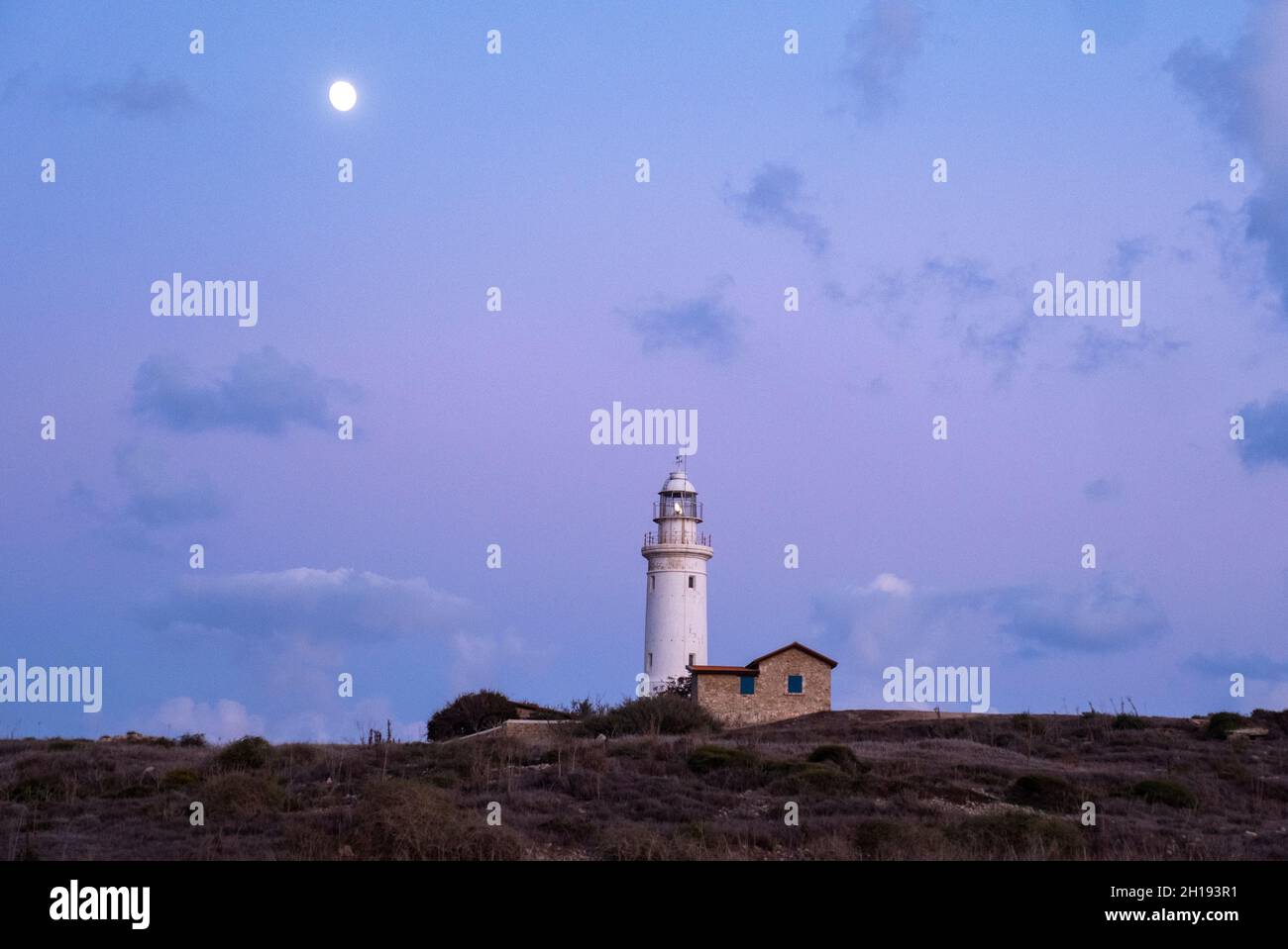 The Moon rises behind the Paphos lighthouse, Paphos Point, Cyprus Stock ...