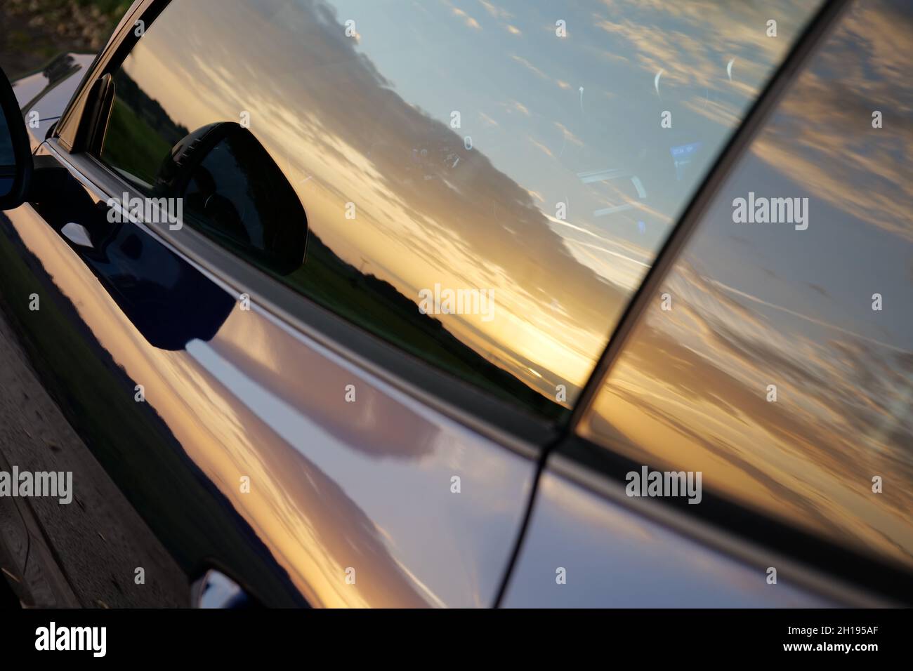 A reflection of sunset scene on the car window Stock Photo - Alamy