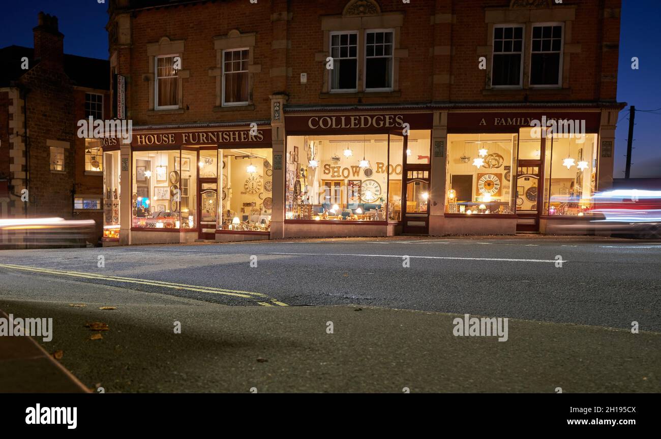 Electrical store window lit up at night in Belper, Derbyshire, UK Stock ...