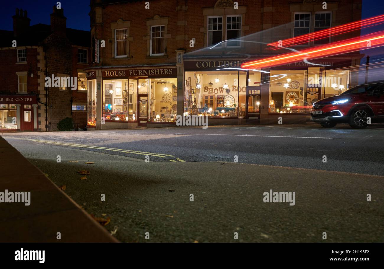 Electrical store window lit up at night in Belper, Derbyshire, UK Stock ...