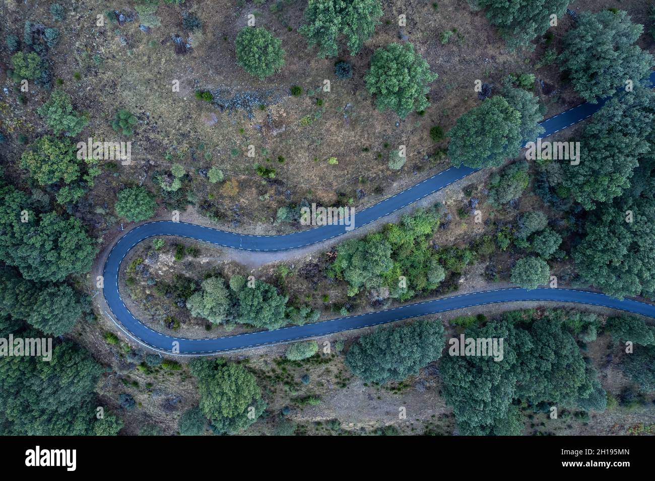 An aerial view of a winding highway through the mountains Stock Photo ...