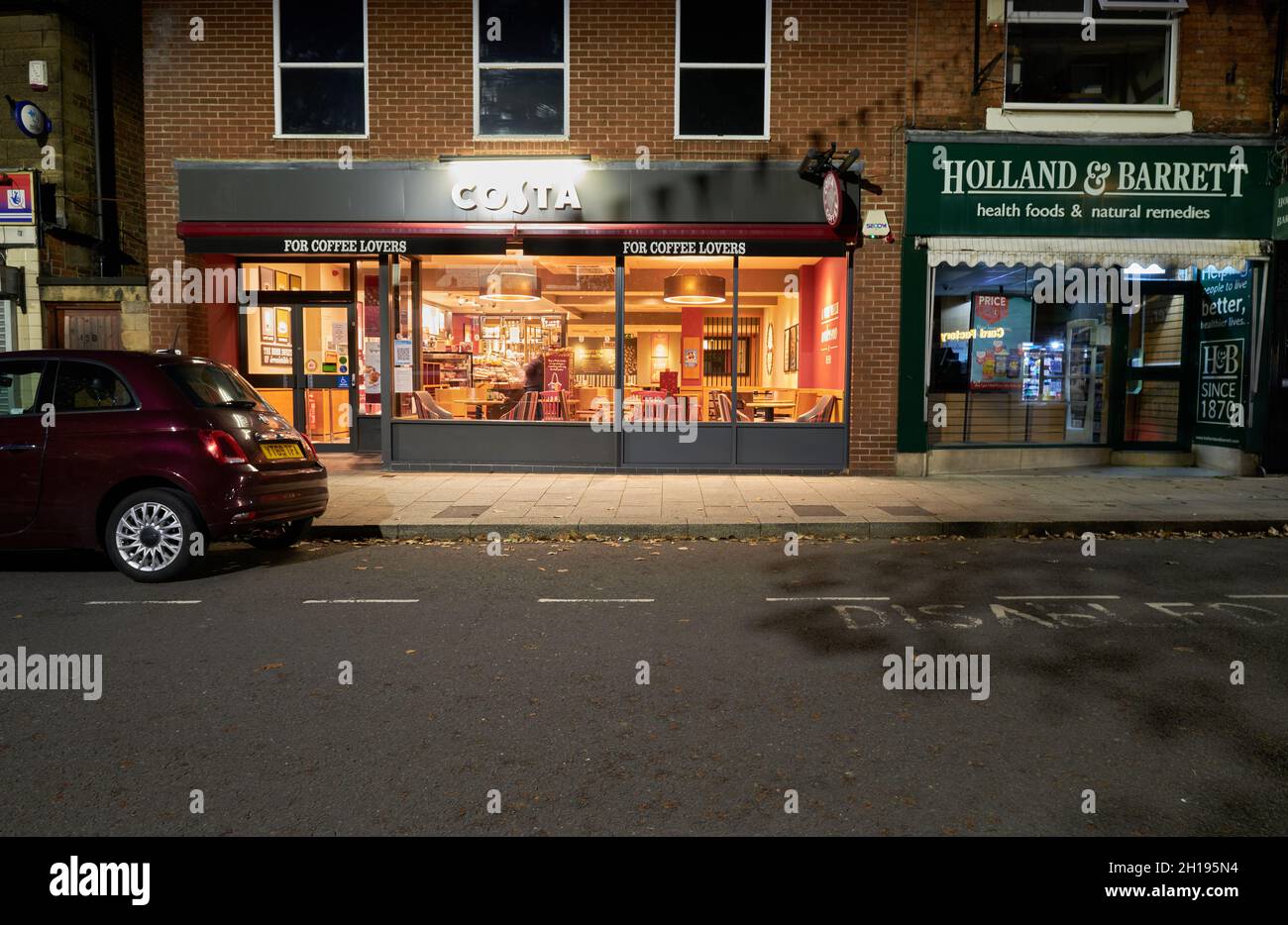 High street coffee house at night in Belper, Derbyshire, UK Stock Photo ...