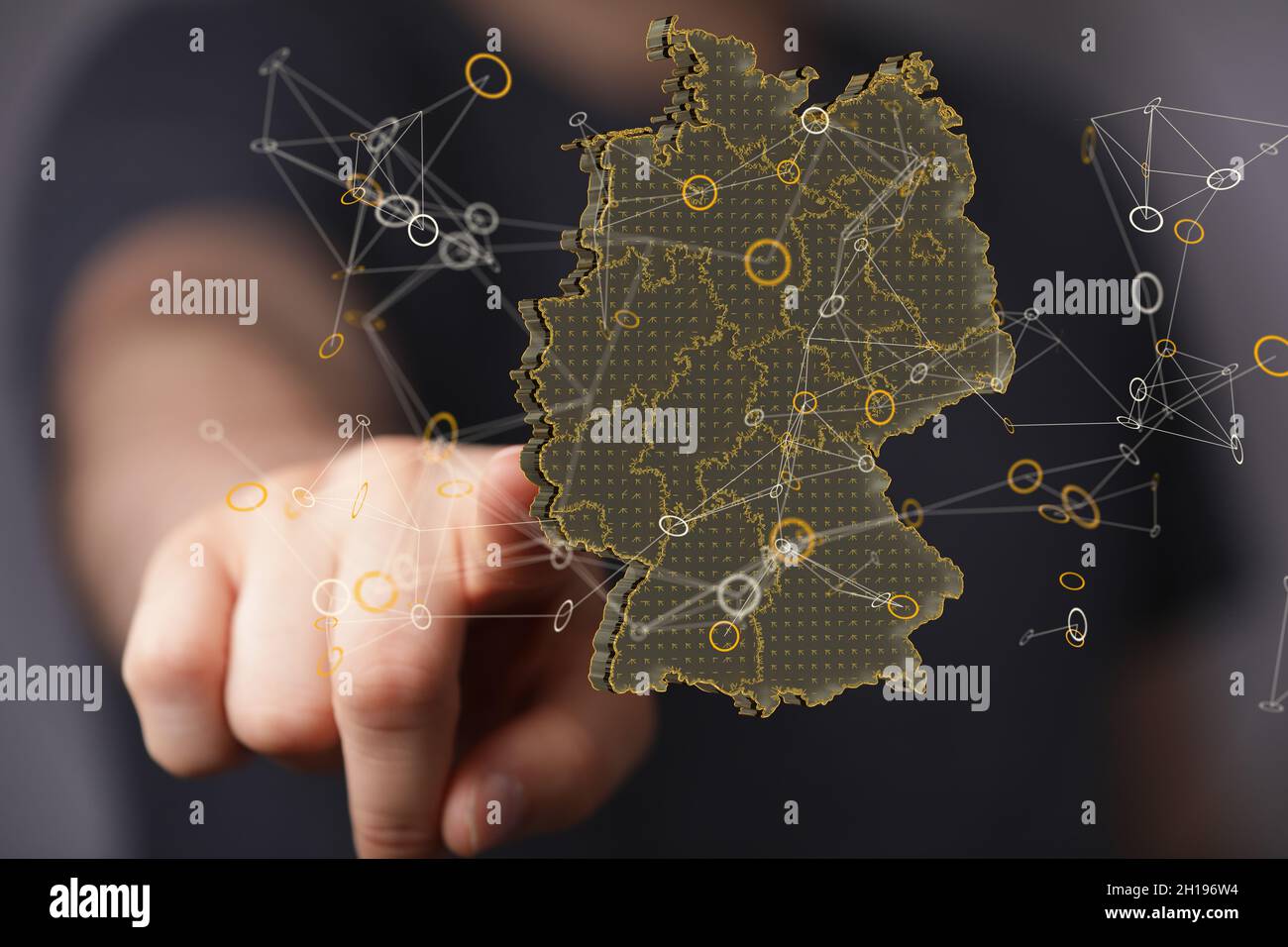A human hand showing a map of Germany consisting of 3D triangles, lines ...