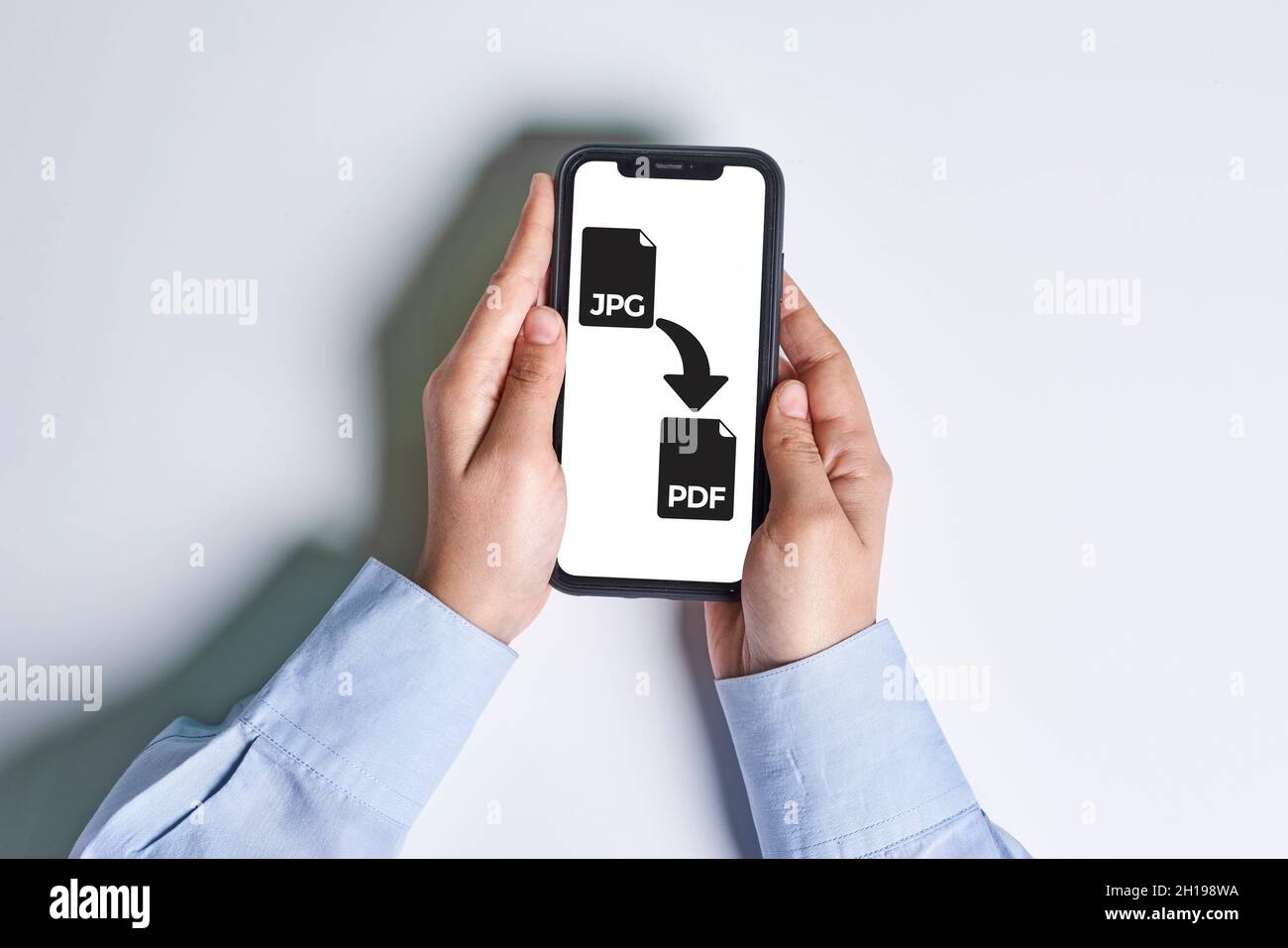 Jpg to Pdf converting on mobile phone. Hands of person holding mobile ...