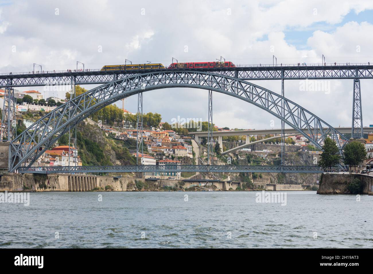 The metro train crossing Douro River on Luís I Bridge from Porto to ...