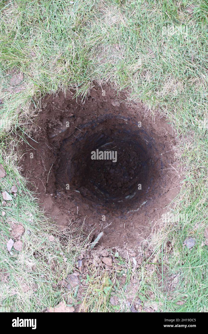 A Deep Hole in Red Shale Soil Stock Photo - Alamy