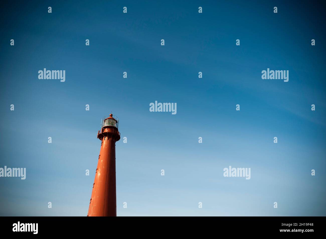 The red lighthouse in Andenes under a bright blue sky. Andenes ...