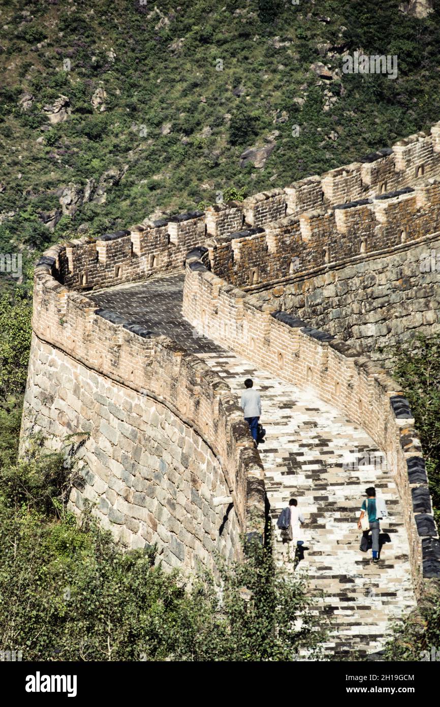 Chinese tourists walk on the Great Wall on the ridge tops above ...