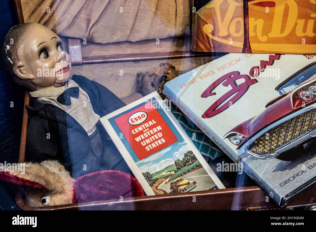 Shop display of an old discarded ventriloquist dummy, map toys and book ...
