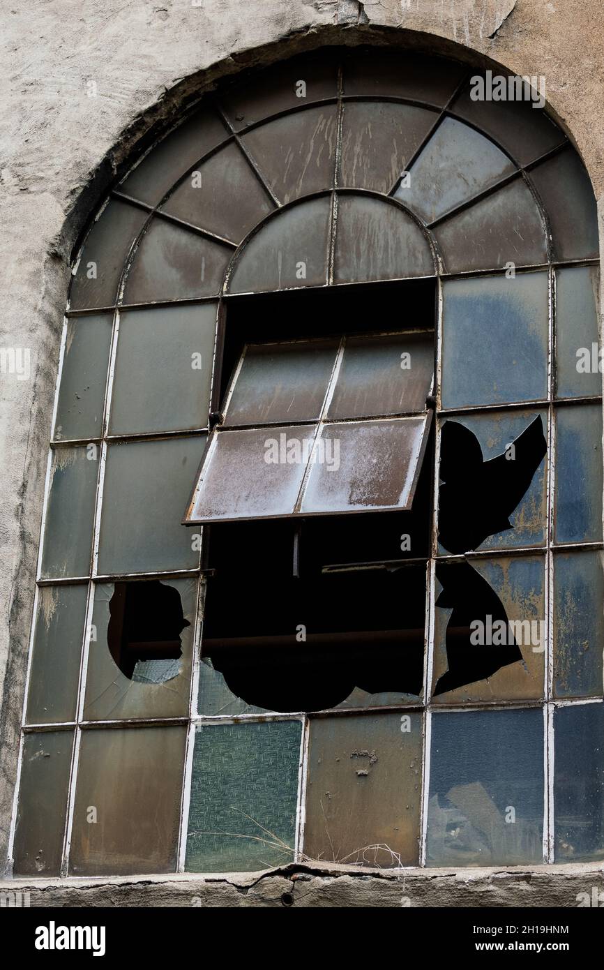A broken window of an old abandoned building Stock Photo - Alamy