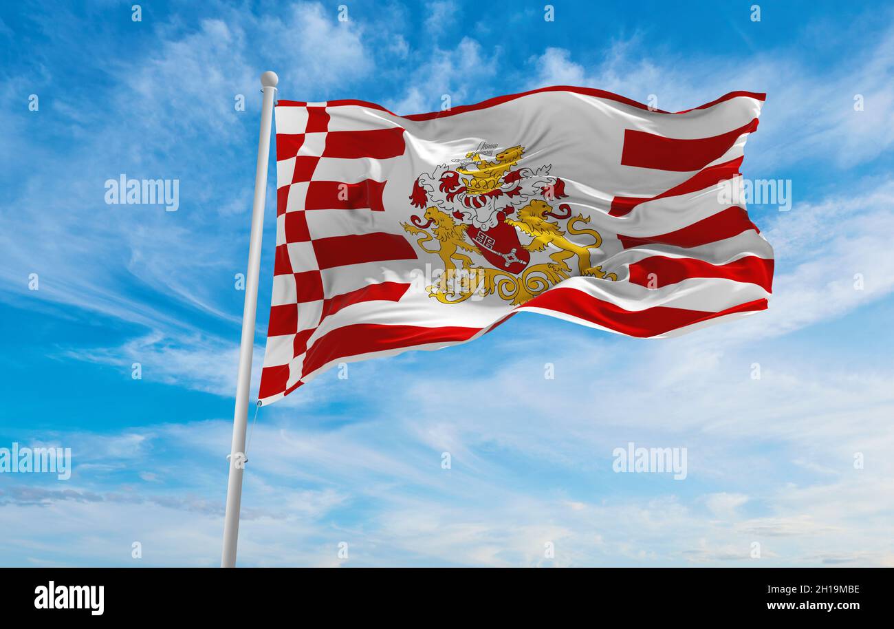 flag of State Bremen at cloudy sky background on sunset, panoramic view ...