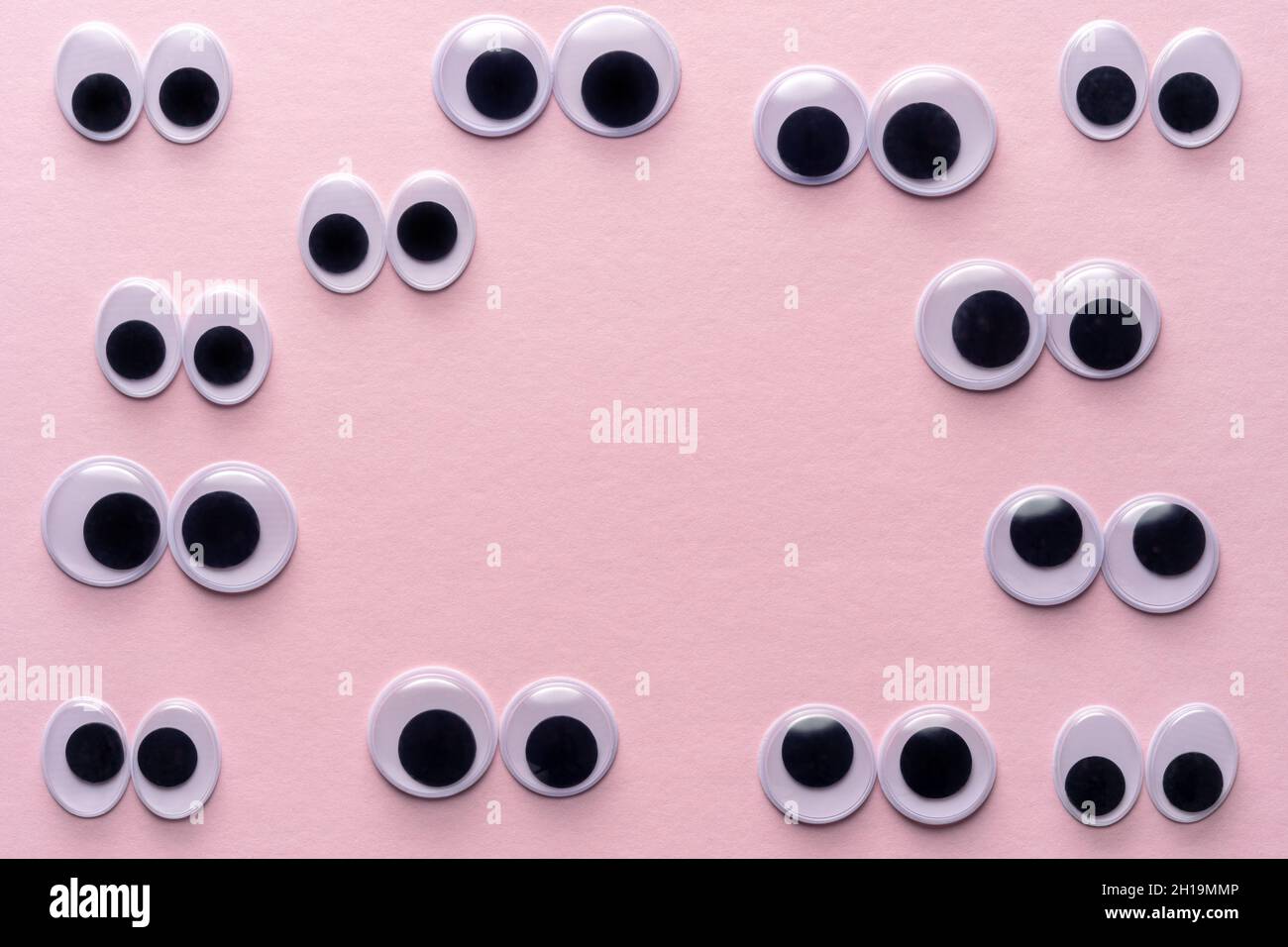 Creative layout of many googly eyes on pink background. Minimal concept ...
