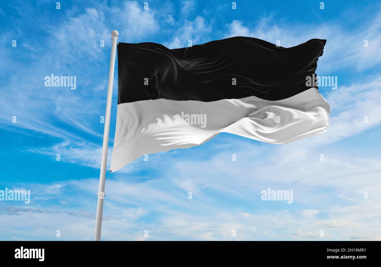 flag of Ulm at cloudy sky background on sunset, panoramic view. Federal ...