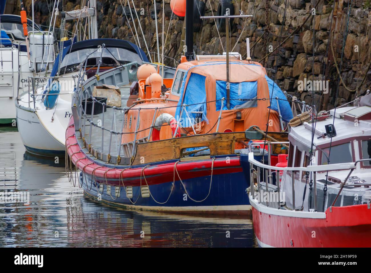 boats moored against the harbour wall Penrhyn Dock Bangor Wales UK ...