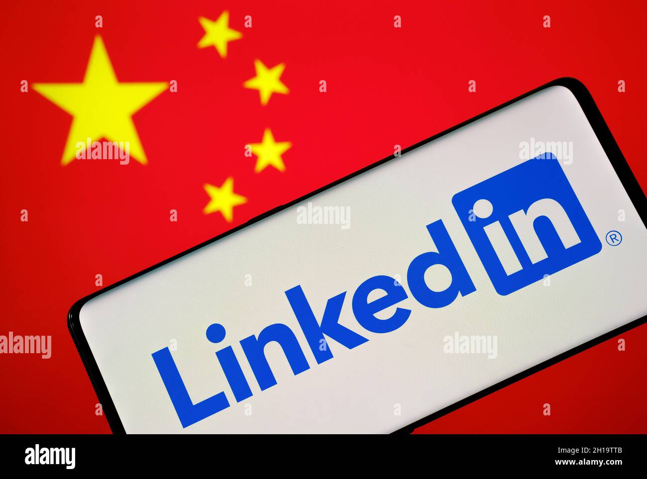 Linkedin logo seen on smartphone and blurred flag of China on the ...