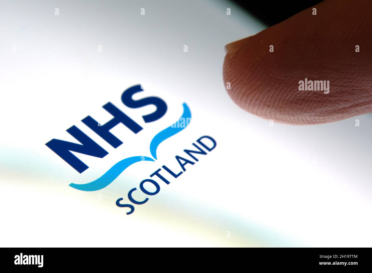 NHS Scotland app login screen seen on smartphone and finger touching it ...