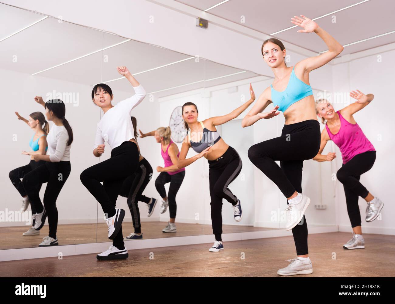 Cheerful different ages women learning swing steps at dance class Stock ...