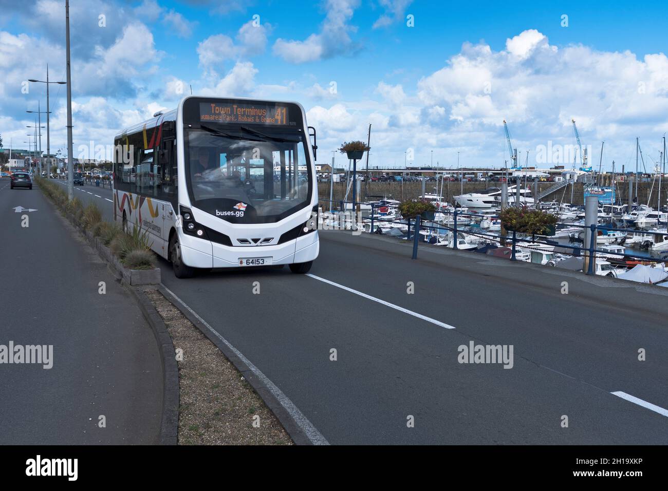 dh Buses service ST PETER PORT GUERNSEY Bus on road by harbour Stock ...