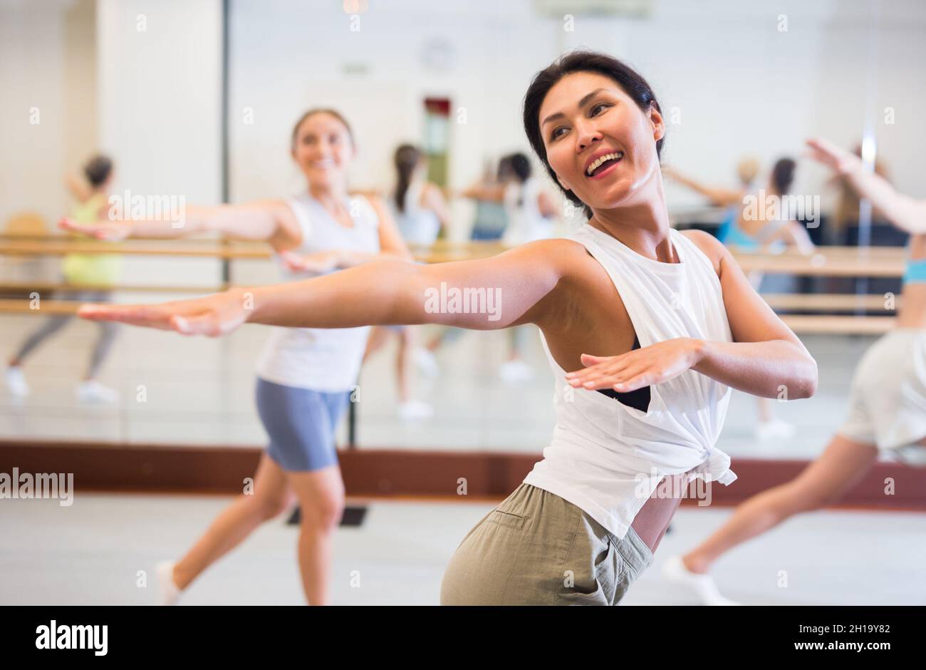 girl dancing modern dance in studio with other dancers Stock Photo - Alamy